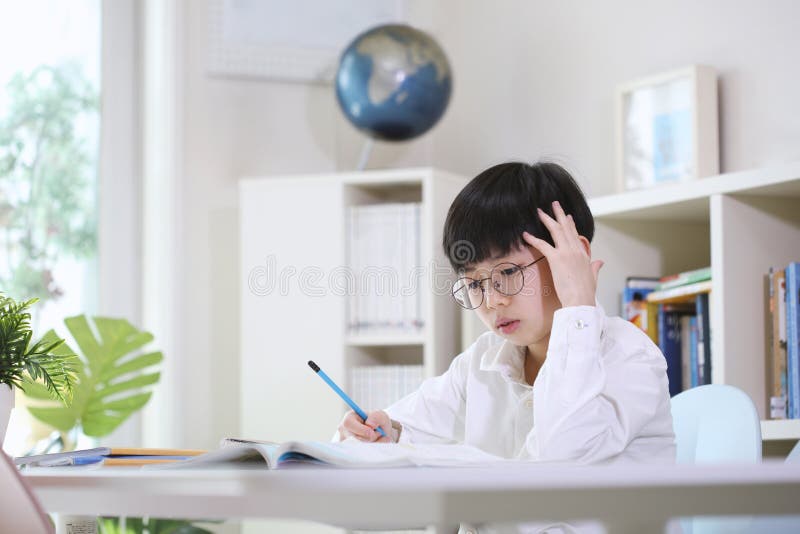 Boy Thinking Carefully, Concentrating and Studying Hard at His Desk ...