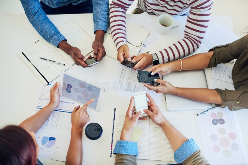 Smart Devices that Get Things Done. a Group of Colleagues Using Smart ...