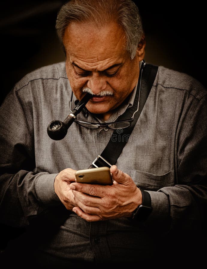 Smart Elderly Man Sending a Text Message on the Smartphone while ...