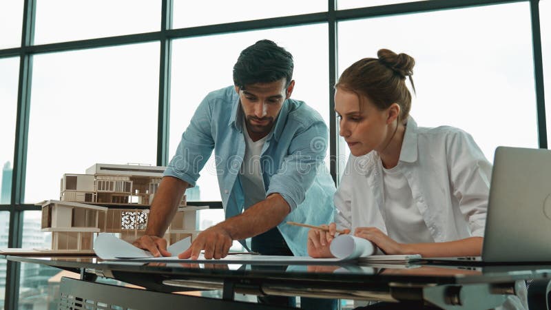 Smart Engineer Inspect House Model while Colleague Using Laptop ...