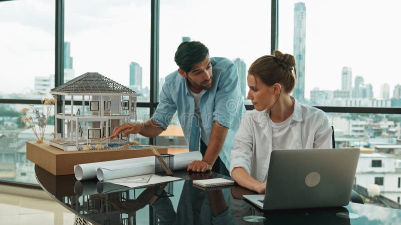 Smart Engineer Inspect House Model while Colleague Using Laptop ...