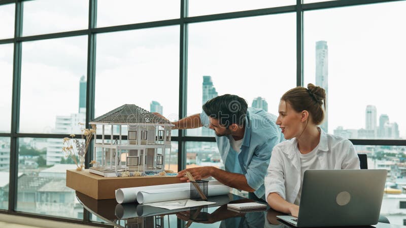 Smart Engineer Inspect House Model while Colleague Using Laptop ...