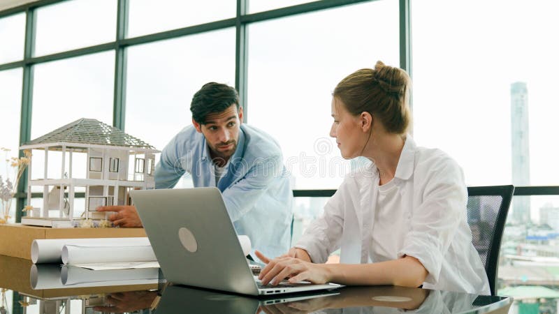 Smart Engineer Inspect House Model while Colleague Using Laptop ...