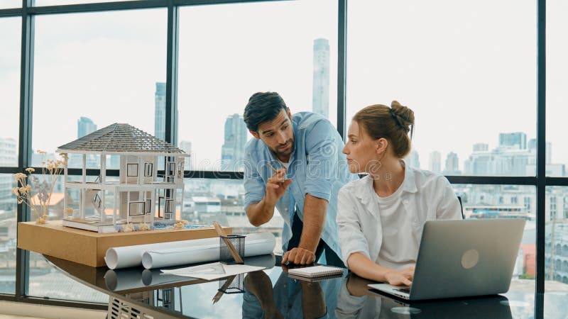 Smart Engineer Inspect House Model while Colleague Using Laptop ...