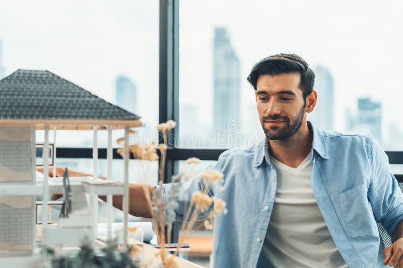 Smart Engineer Inspect House Model while Sitting at Skyscraper Office ...
