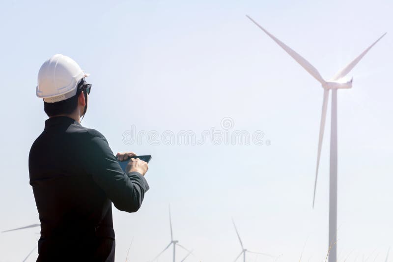 Smart Engineer Man Stands Using Tablet Front the Wind Turbines ...