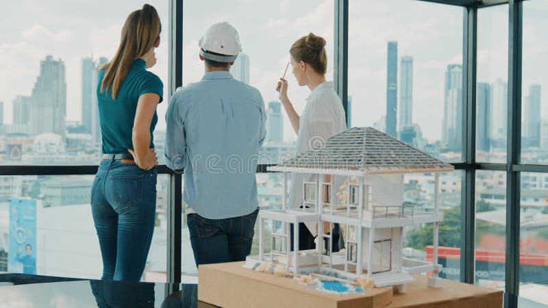 Smart Engineer Team Talking while Look at Skyscraper. Back View ...