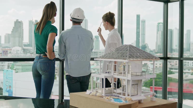 Smart Engineer Team Talking while Look at Skyscraper. Back View ...