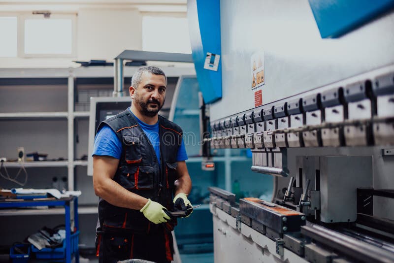 A Smart Factory Worker or Engineer Makes Machines in a Production ...