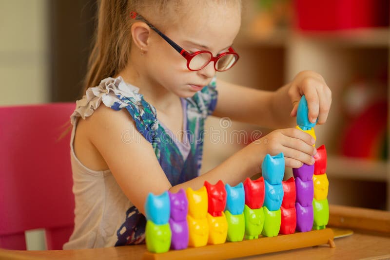 Smart Girl with Down Syndrome Learns To Sort by Colors Stock Photo ...