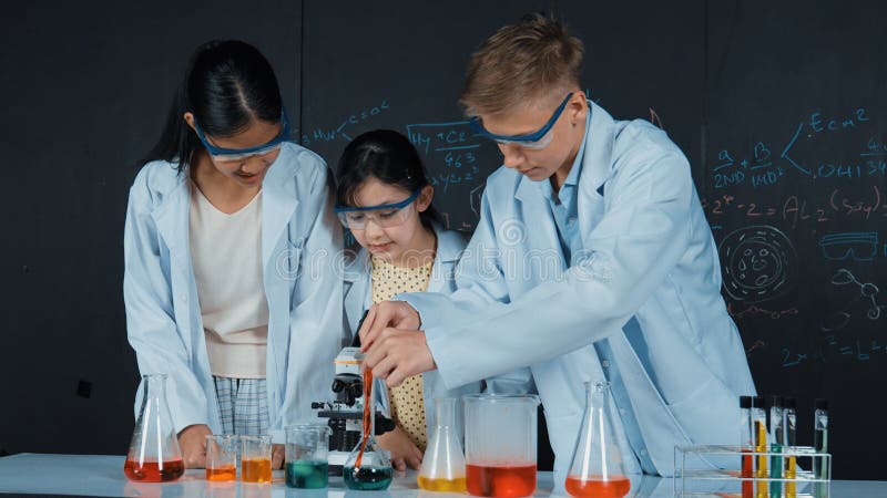 Girl Pour Colored Solution in To Beaker while Student Excited ...