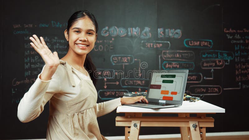 Smart Girl Waving To Camera while Programing Code at Blackboard ...