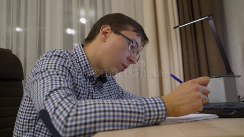 Smart Guy Solves Problems at Home at the Table. Math Tutor. a Pensive ...