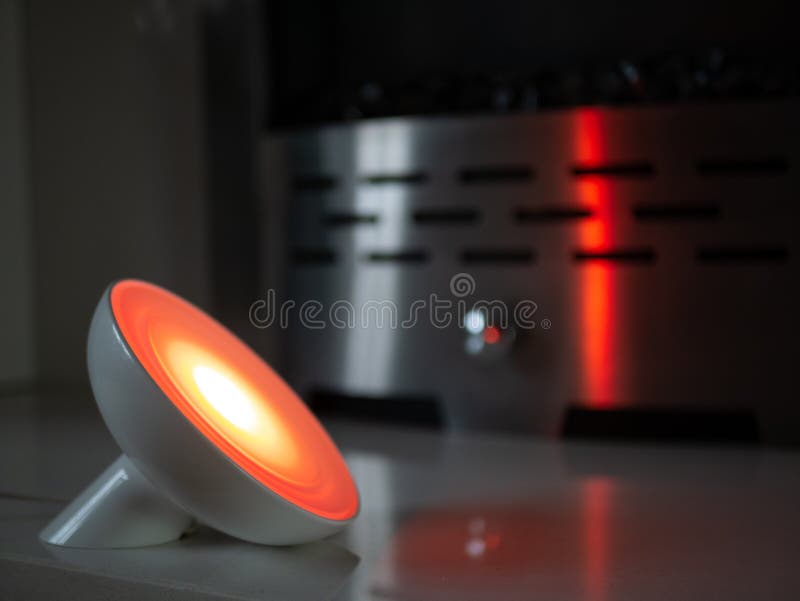 Smart Home Lamp Light with Coloured LED on Fireplace - Orange Stock ...