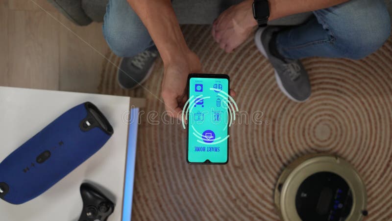 Top View Close Up Shot of Man on the Sofa Holding Smartphone, Using App To Switch on Music ...