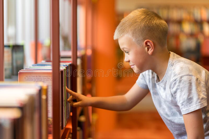Smart Intelligent Preschool Kid Choosing Books in School Library Stock ... Smart Intelligent Preschool Kid Choosing Books in School Library Stock ...