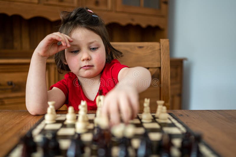 A Smart Little Girl Playing Chess Stock Photo - Image of little ...