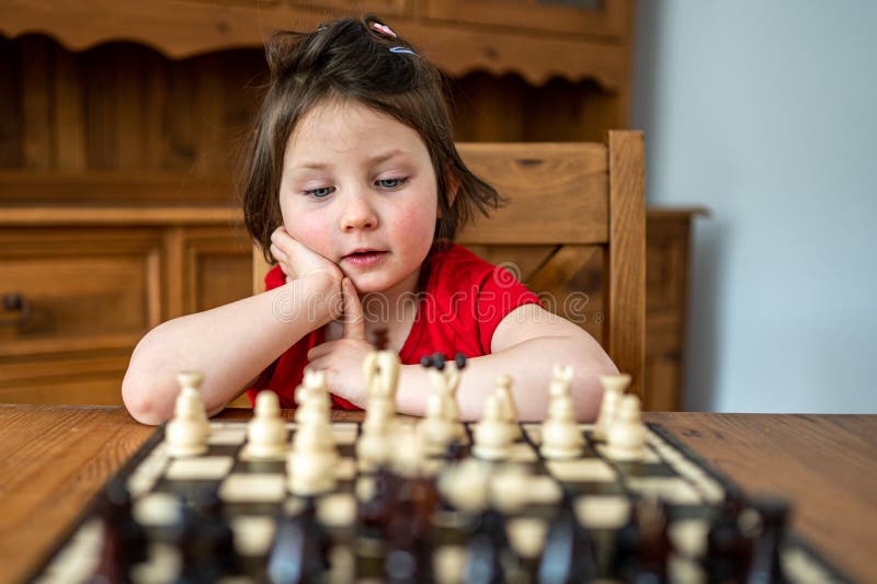 A Smart Little Girl Playing Chess Stock Image - Image of confusion ...