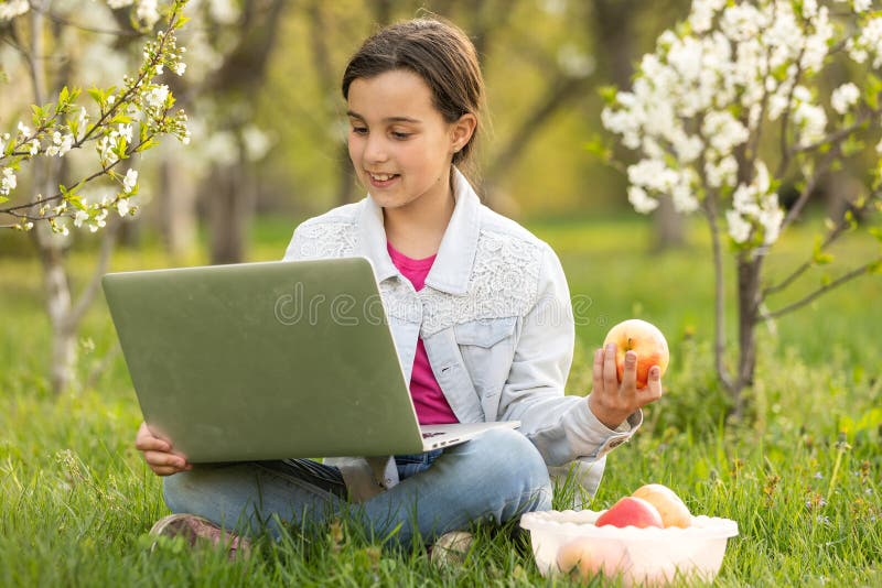Smart Little Girl Using Her Laptop in the Garden. Stock Photo - Image ...