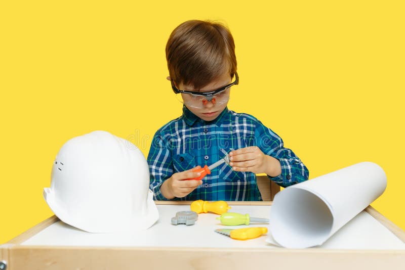Smart Little Kid Boy Engineer or Architect Sitting at the Work Table ...
