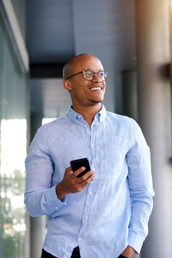 Smart Looking African Businessman Walking with Cellphone Stock Photo ...