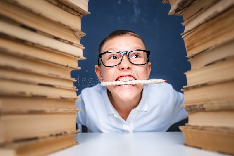 Smart Looking Boy Holding Pencil in His Mouth, Looking Away and Stock ...