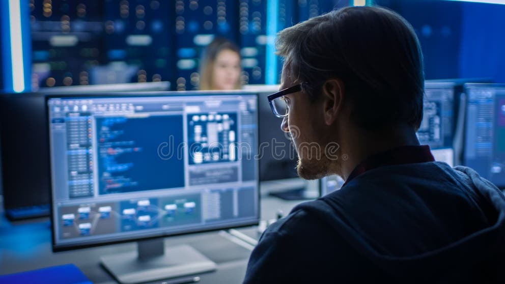 Smart Male it Programer Working on Desktop Computer in Data Center ...