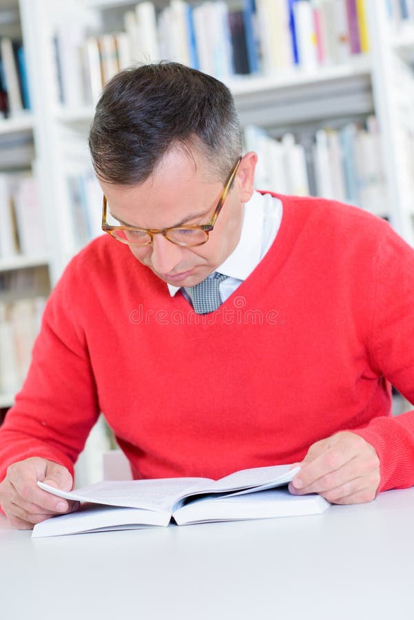 Smart Man Reading in Library Stock Photo - Image of professional ...