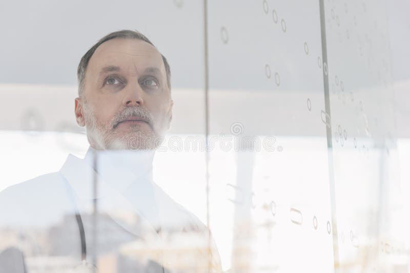 Smart Mature Doctor Making Serious Decision Stock Photo - Image of coat ...