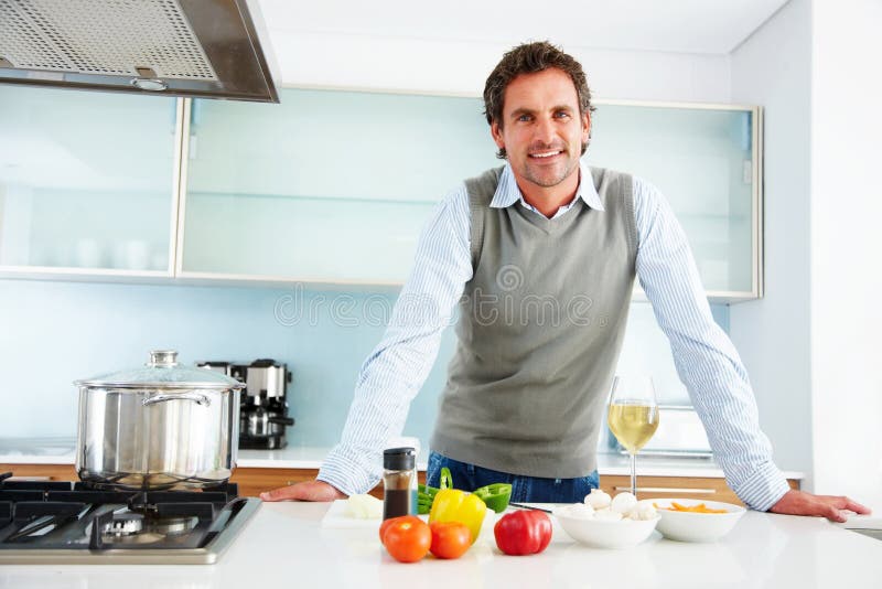 Smart Mature Man Standing in Kitchen. Portrait of a Smart Mature Man ...
