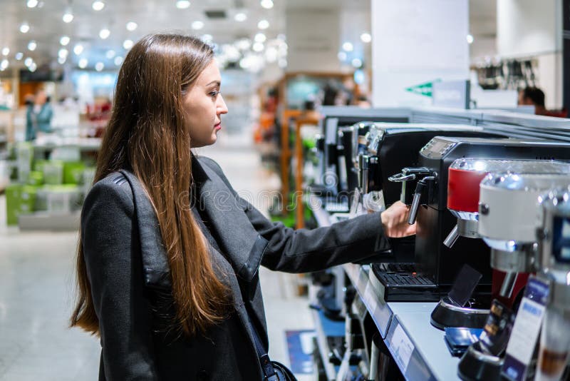 Female Customer Buying Spray Paint Can In The Supermarket. Stock Image ...