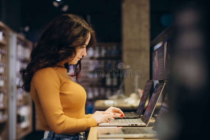 Smart Modern Female Customer Choosing Laptop in the Computer Shop ...