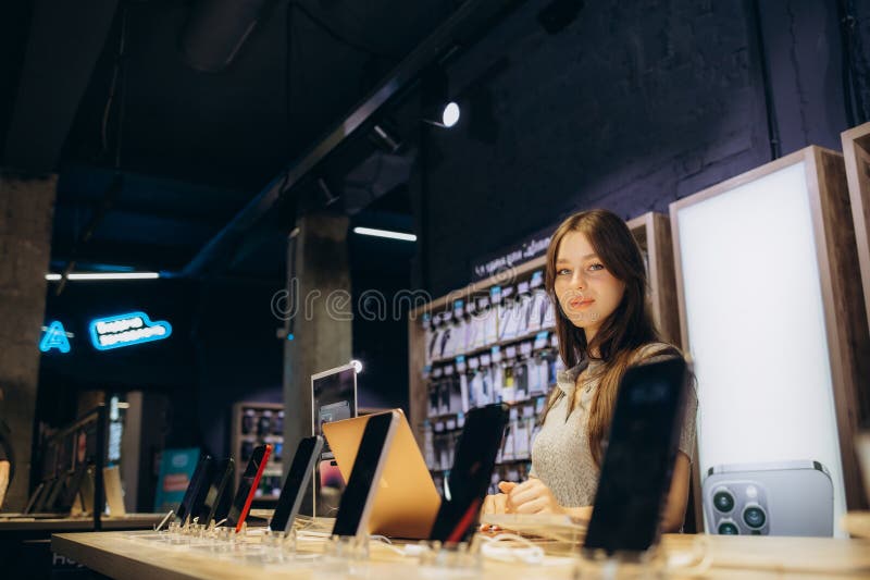 Smart Modern Female Customer Choosing Laptop in the Computer Shop ...
