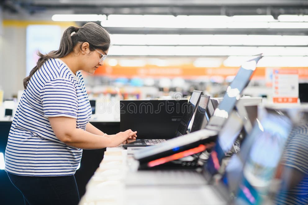 Smart Modern Female Customer Choosing Laptop in the Computer Shop ...