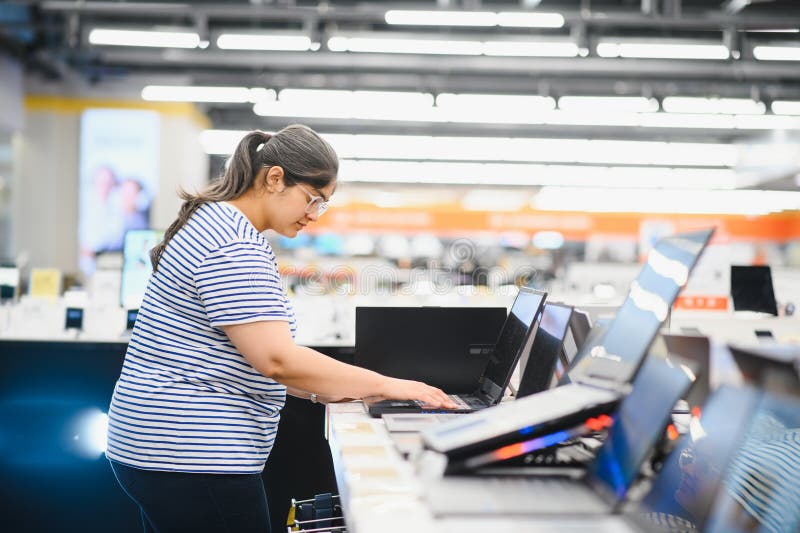 Smart Modern Female Customer Choosing Laptop in the Computer Shop ...