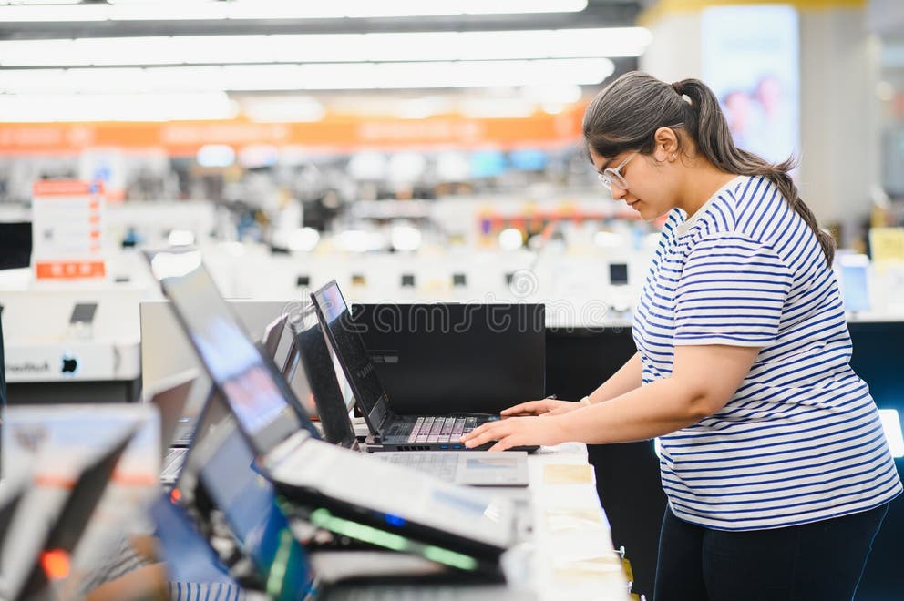 Smart Modern Female Customer Choosing Laptop in the Computer Shop ...