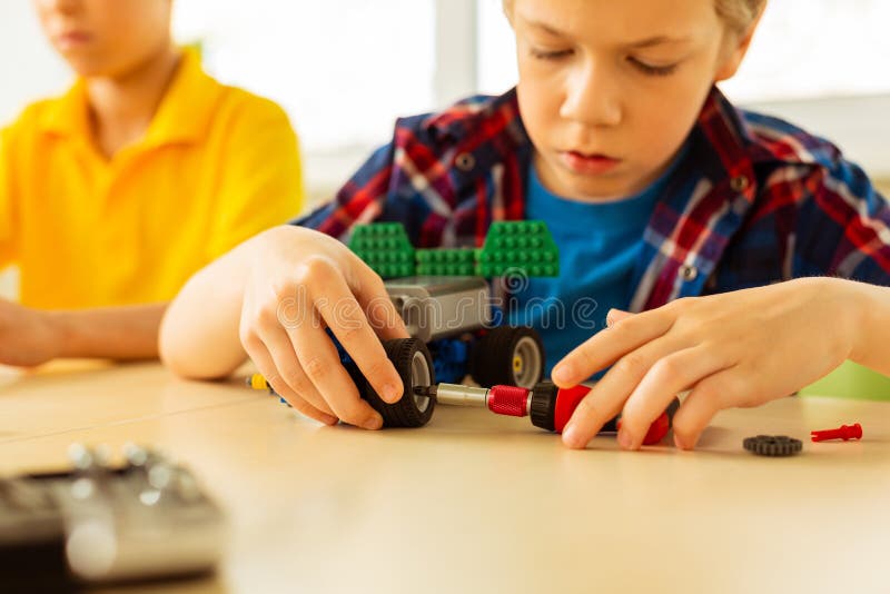 Smart Nice Boy Putting Car Details Together Stock Photo - Image of ...