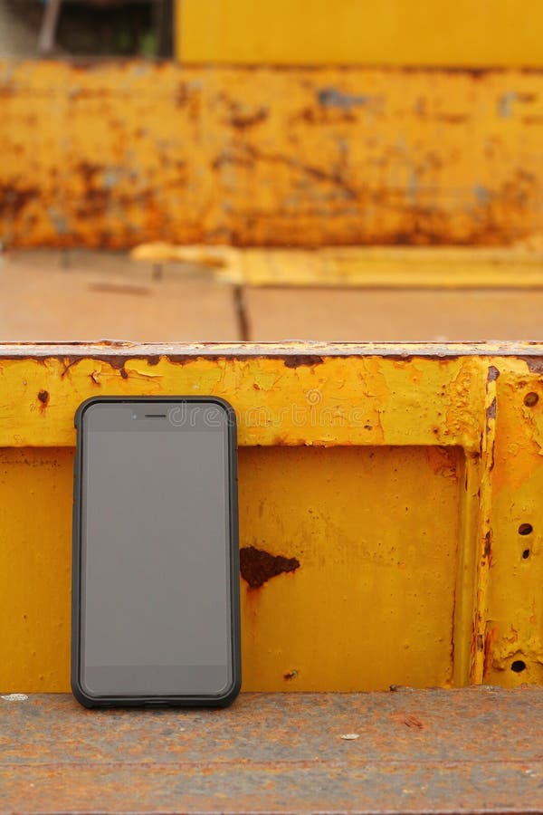 Smart Phone on Background of Yellow Steel. Stock Image - Image of ...