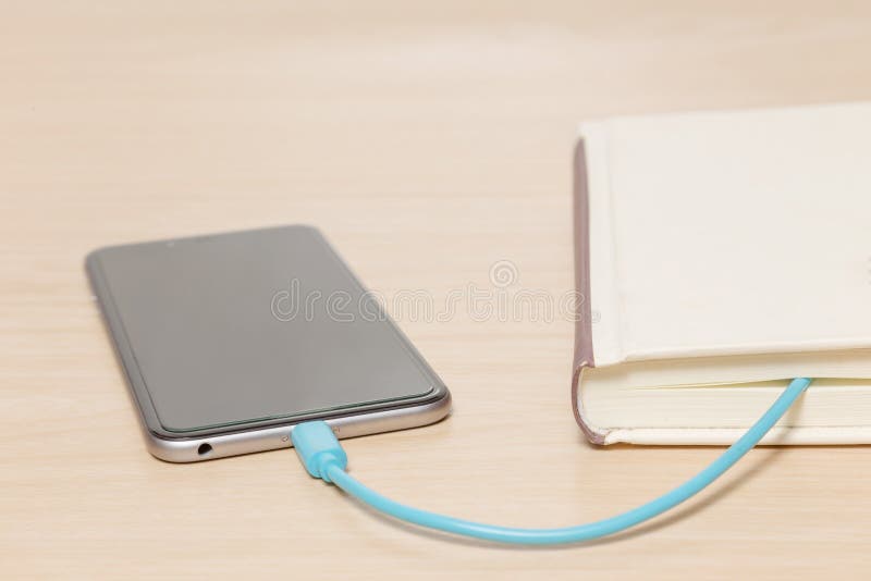Smart Phone Connected To the Old Book with a Cable Stock Image - Image ...