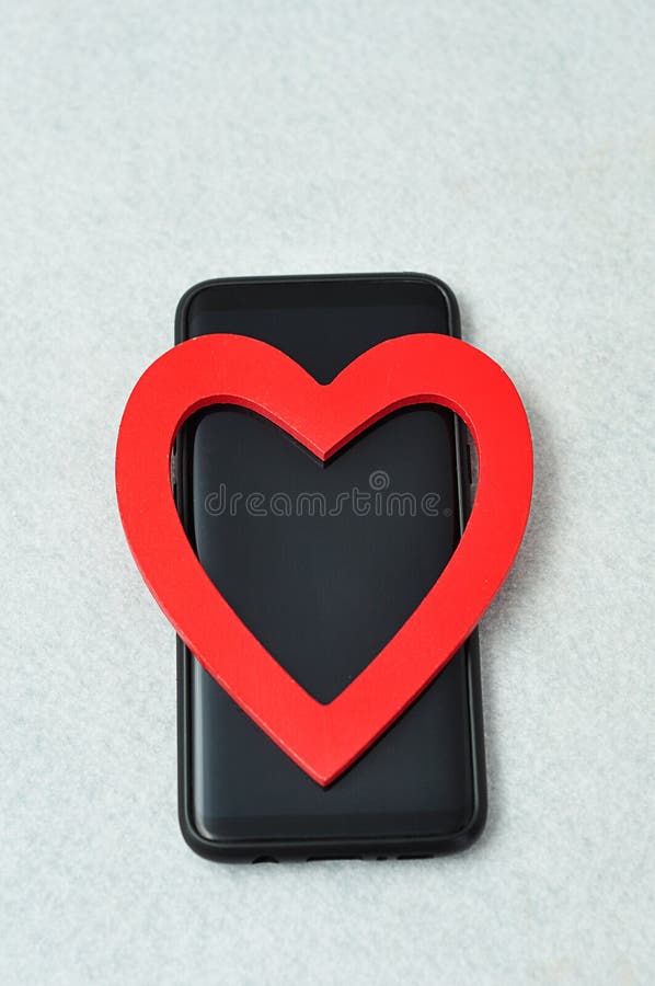 A Smart Phone Displayed with a Red Wooden Heart Stock Photo - Image of ...