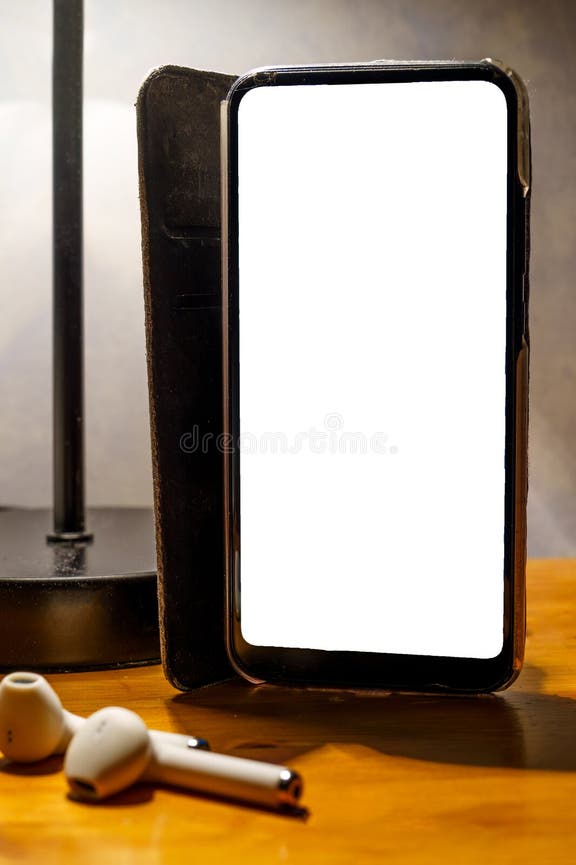 Smart Phone with Flip Case and Empty White Screen on Bedside Table ...