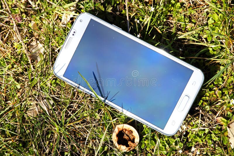 Smart phone in grass stock image. Image of green, lost - 68944295