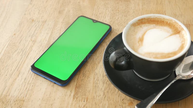 Smart Phone with Green Screen and Coffee Cup on Table Stock Video ...