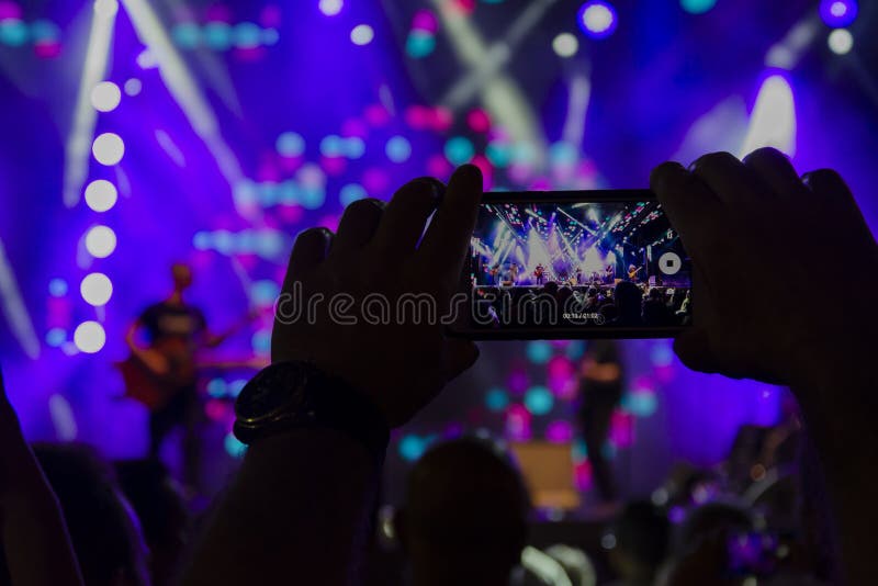 Smart Phone on the Hand during a Live Concert with Toned Special Effect ...