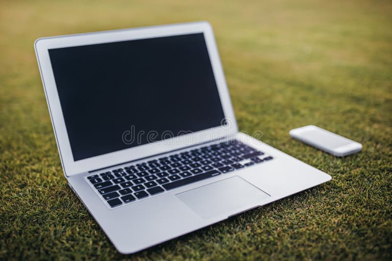 Smart Phone and Laptop on Green Grass Stock Photo - Image of computer ...