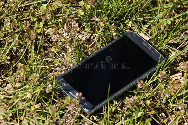 Smart phone lying on grass stock image. Image of screen - 68944291