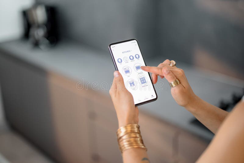 Controlling Smart Devices with Phone on the Kitchen Stock Image - Image ...