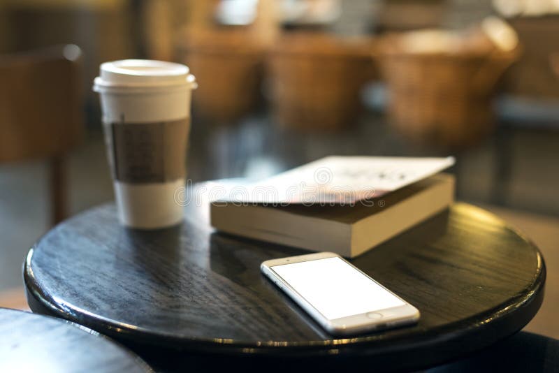 Smart phone on the table. stock image. Image of book - 130129479