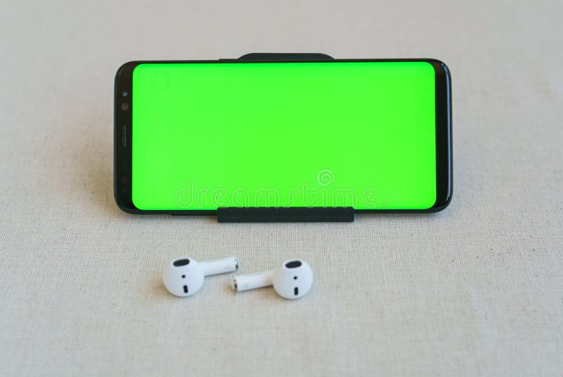 Smart Phone and Wireless Headphones on Table Stock Photo - Image of ...