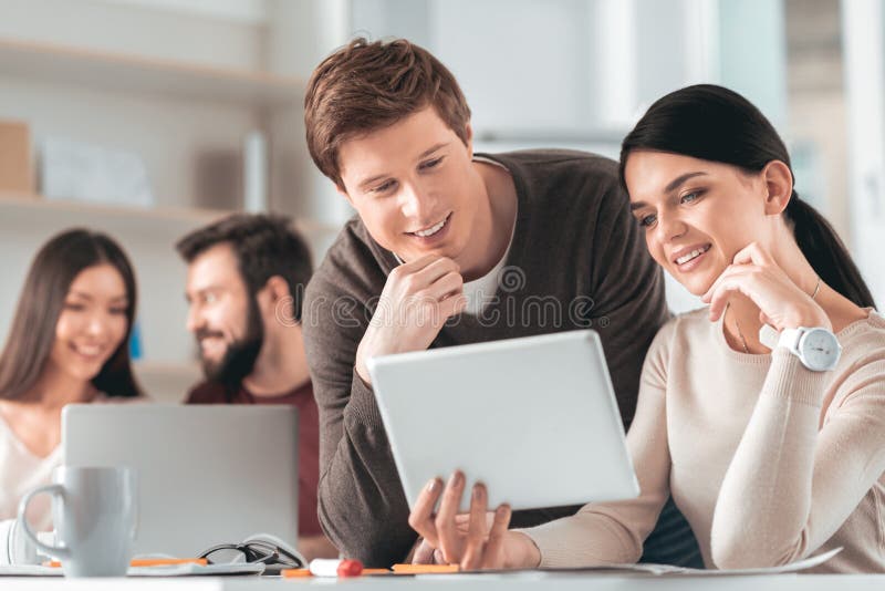Smart Positive Colleagues Looking at the Tablet Screen Stock Image ...